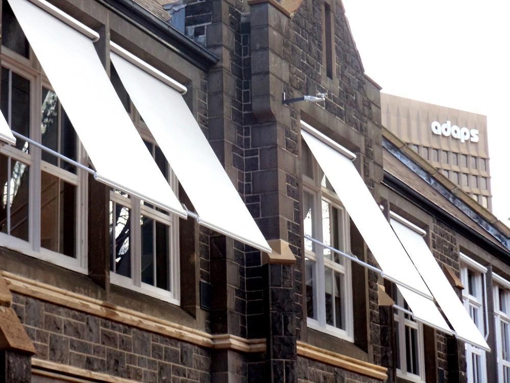 Privacy and attenuation of light in an attractive Drop-Arm Awning by Warema - Shade Factor